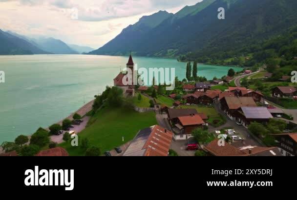 Drone view of traditional Swiss houses rooftops on the shore of a lake ...