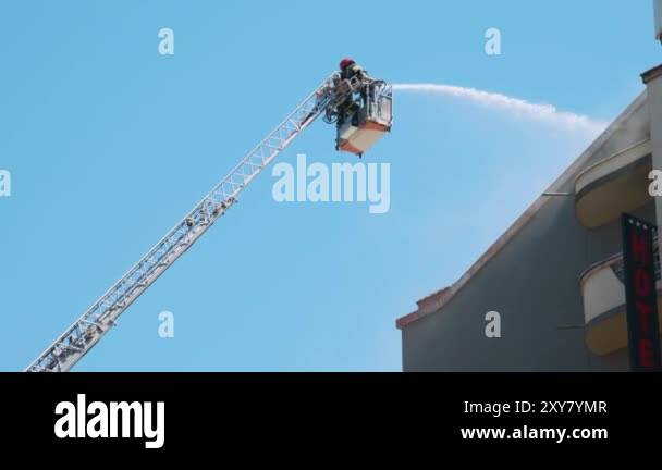 Firefighters in elevated platform extinguish burning house using ...