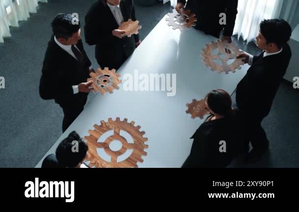 Top view of smart business people gather wooden cog together at meeting ...
