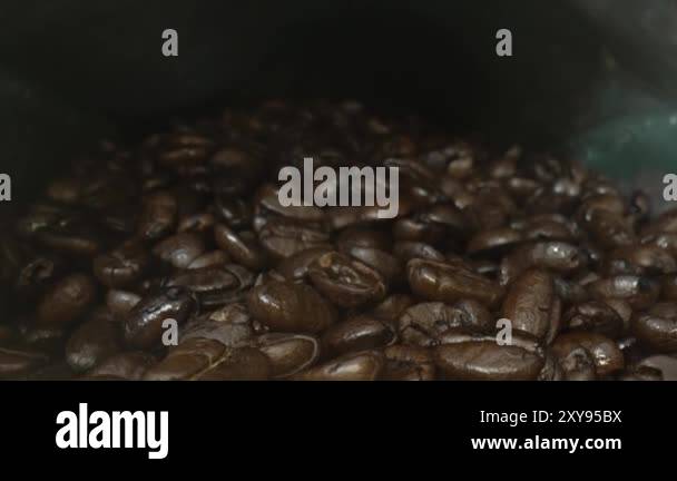 Pile of roasted coffee beans gathering and scattering at separated ...