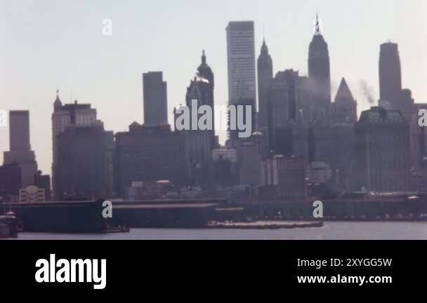 Panorama of Manhattan skyscrapers backlit, viewed from a ship ...