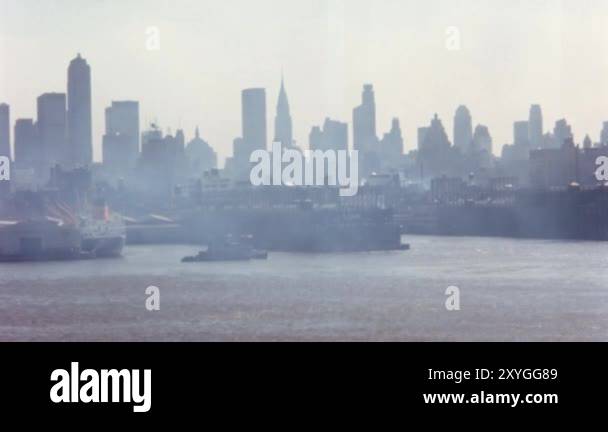 Manhattan skyscrapers viewed in backlight and fog from a moving ship in ...