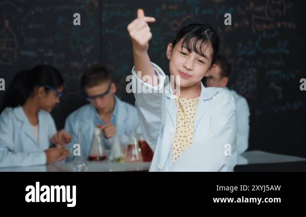 Asian scientist show miniheart to camera while diverse group doing ...