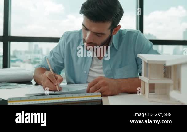 Skilled architect engineer writing house construction on blueprint at ...