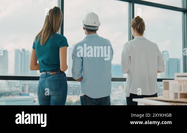 Smart architect engineer team in casual outfit talking while look at ...