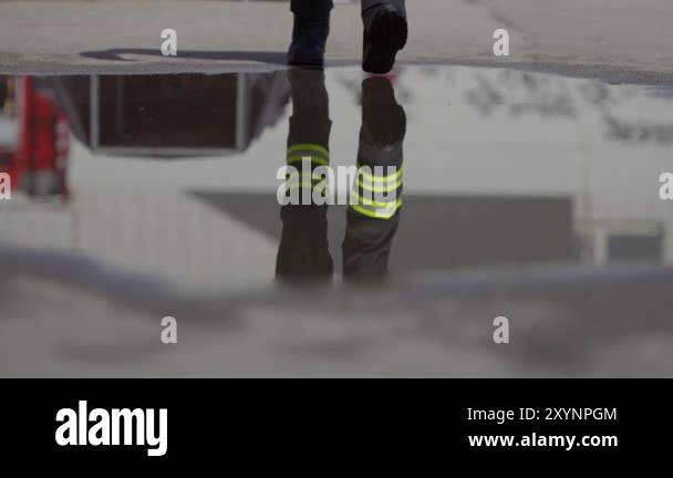 reflective scene captures a firefighter heading into a dangerous ...