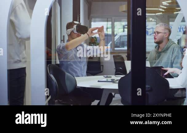 A diverse group of businessmen collaborates and tests a new virtual ...