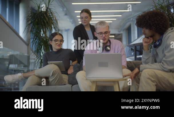 A diverse group of colleagues exchange business experiences, engage in ...