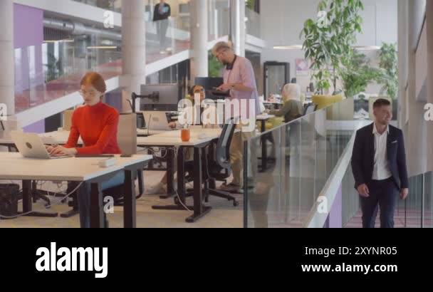 A director arrives at a large, modern office, where he joins his ...