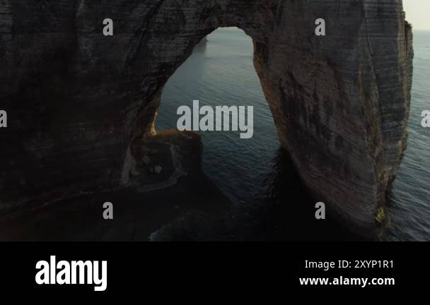 Discover the stunning beauty of a natural rock arch at Etretat, where ...