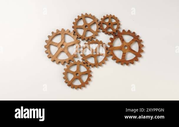 Panorama video of wooden cogwheel gear separate each other symbolize ...