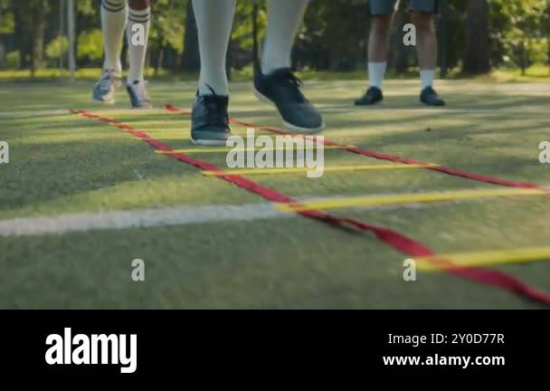 Low section of two male players wearing sports shoes and white socks ...