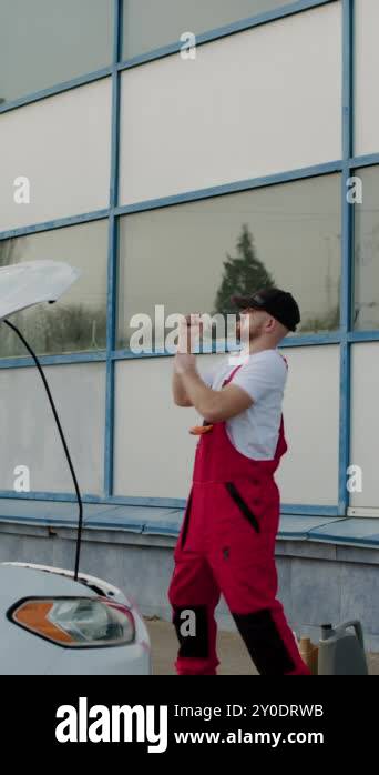Male mechanic figure dancing next to the customers car that he ...