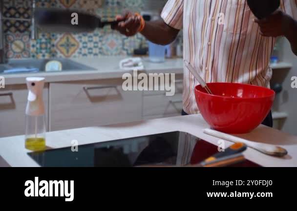 African American father man hand frying pancakes together with daughter ...