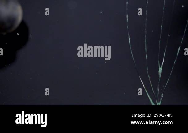 Close-up of shattered glass with intricate cracks and splinters ...