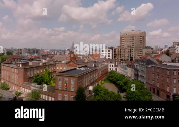 Birds eye view of the Brussels skyline pans across rooftops, a church ...