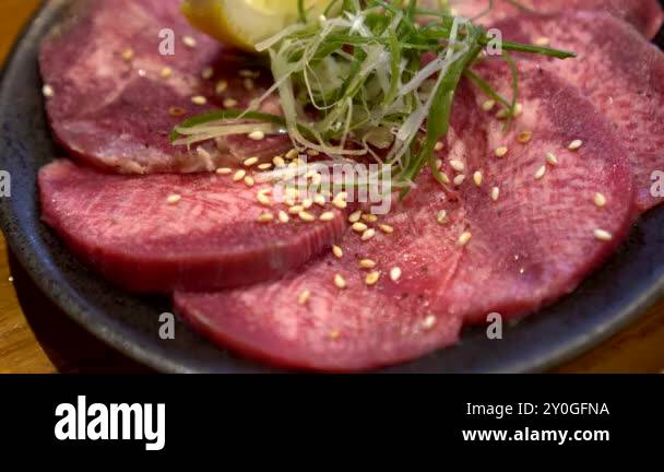 Slice of beef ox tongue gyutan lemon Japanese yakiniku bbq food Stock ...