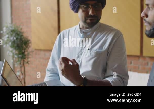 Indian male CEO holding laptop with presentation on screen and ...