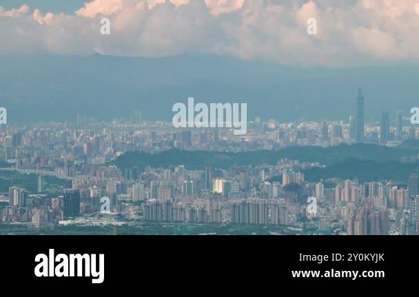A serene aerial view of Taipei City on a sunny afternoon. A massive ...