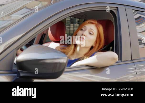 Aggressive nervous lovely redhead middle aged female driver in ...