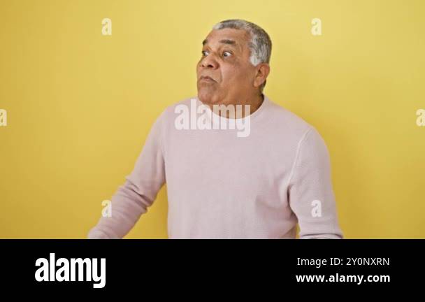 Enraged grey-haired middle age latin man furiously screaming, flaunting ...