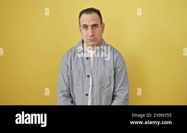 Depressed young hispanic man, upset and crying, showing raw emotion ...