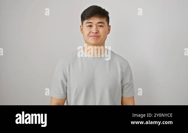 Handsome young chinese man in love, standing cheerfully, wearing a t ...