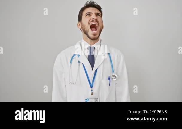 Furious young hispanic man doctor, frustrated and enraged wearing ...