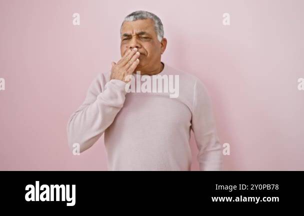 Shocked latin man, middle age, grey-haired, wearing sweater, quietly ...