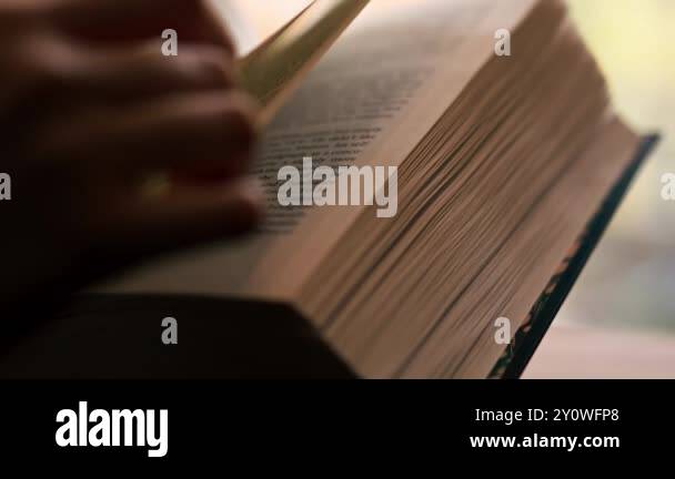 close up hand hold book in a bookstore near the window a beautiful ...