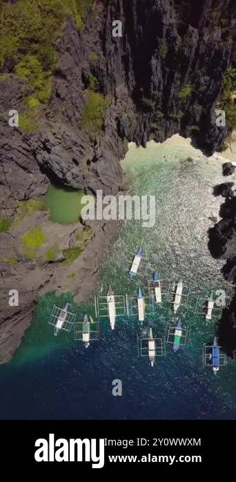 Vertical aerial view of secret Lagoon beach with filipino boats in El ...