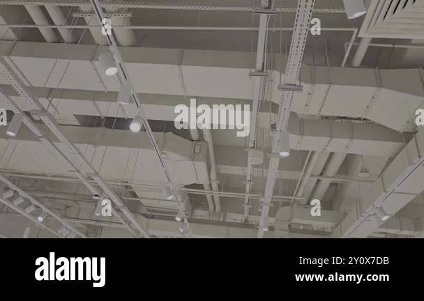 Industrial ceiling showcasing exposed ductwork, lighting fixtures, and ...