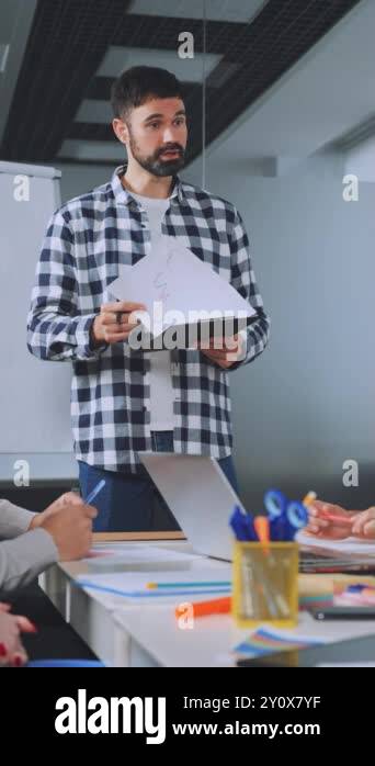 Vertical screen: Team members clapping for presentation in office ...
