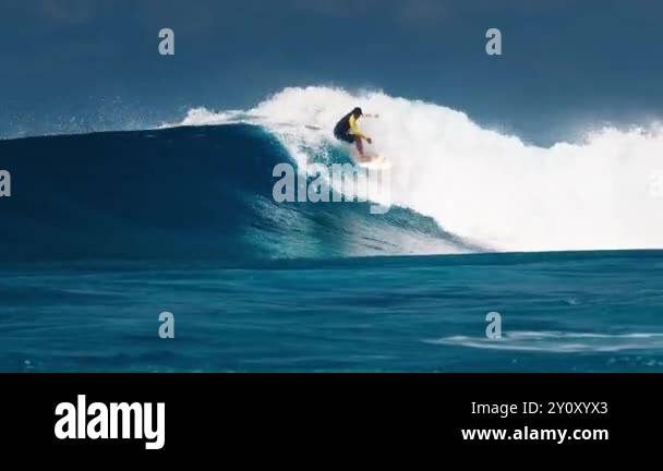 Experienced surfer rides huge, double overhead ocean wave at the famous ...