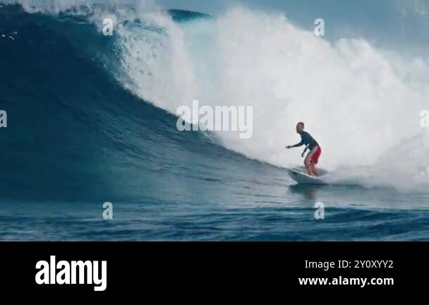 Experienced surfer rides huge, double overhead ocean wave at the famous ...