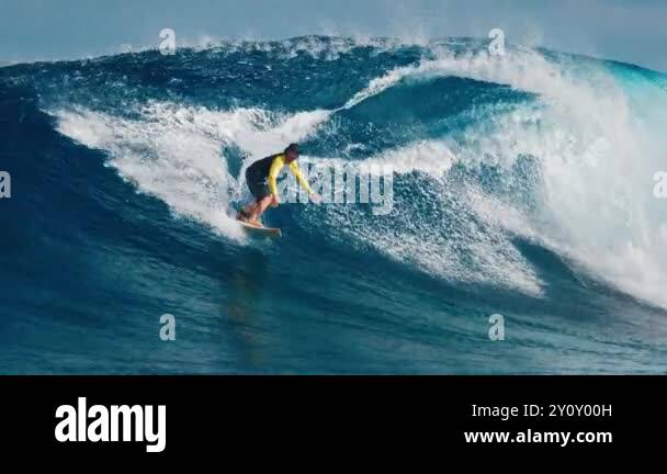 Experienced surfer rides huge, double overhead ocean wave at the famous ...