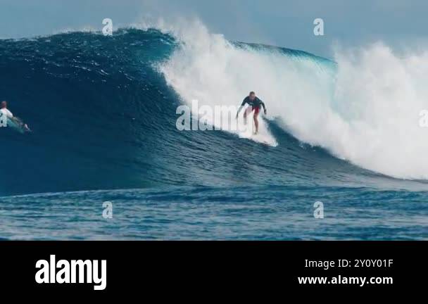 Experienced surfer rides huge, double overhead ocean wave at the famous ...