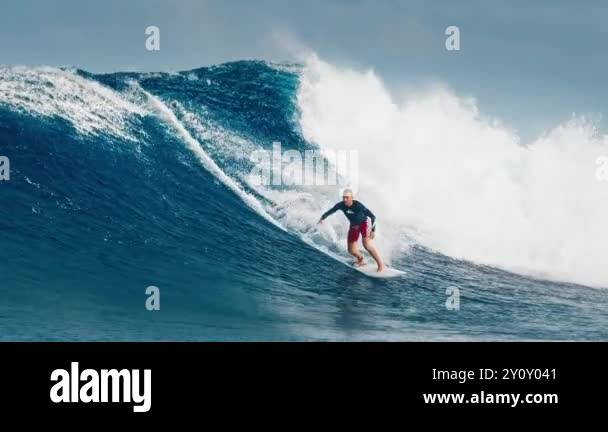 Experienced surfer rides huge, double overhead ocean wave at the famous ...