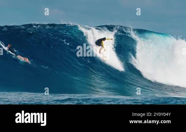 Experienced surfer rides huge, double overhead ocean wave at the famous ...