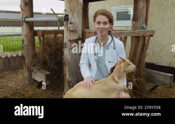 Medium full portrait of happy beautiful young Caucasian female vet in ...