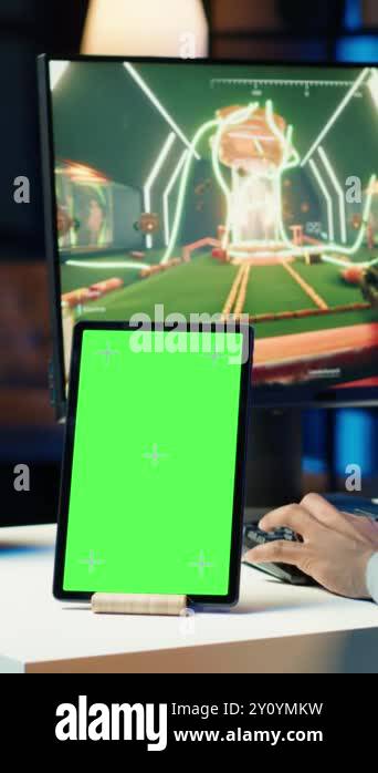 Vertical video Chroma key tablet next to man playing high FPS ...