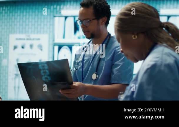 Physicians and radiologists analyzing x ray scans to create an effective treatment plan. Medics ...