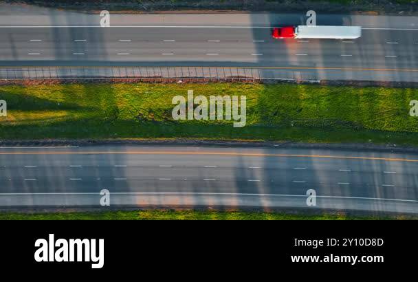 Lorries and cars drive by the highways to both sides. Top view on the ...