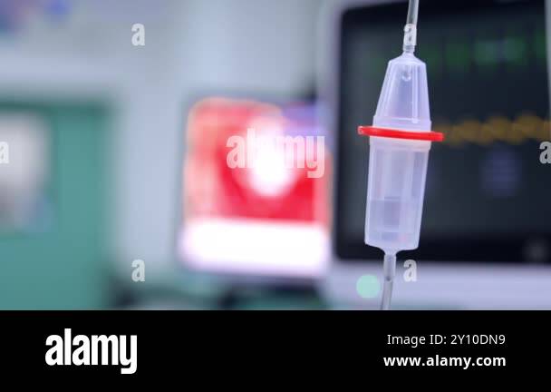 Saline solution dripping inside the Iv drip reservoir. Close up ...