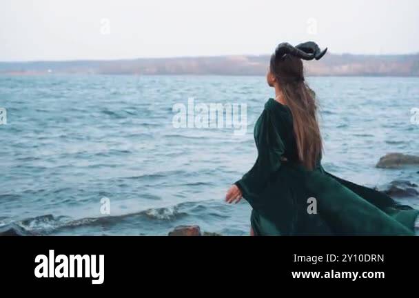 mystic lady with long hair in flying gorgeous green dress, witch in ...