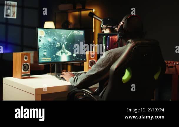 Man wearing headphones playing game, teaching subscribers professional ...