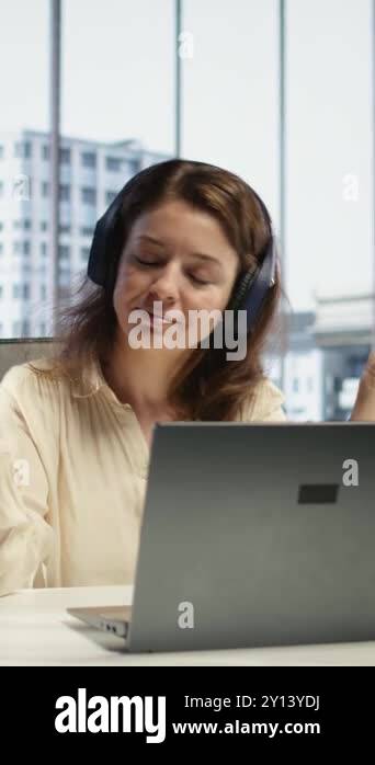 Vertical Video Female entrepreneur enjoys multitasking with her ...