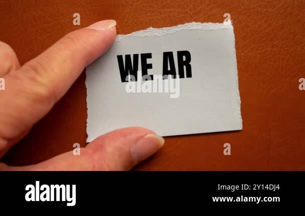 We are hiring message writing on ripped torn paper on brown background. Conceptual we are hiring ...