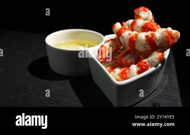 A shrimp-shaped bowl of Surimi stands on the Black Stone and rotates ...