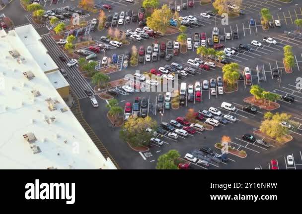 Many parked cars on store parking lot with lines and markings for ...